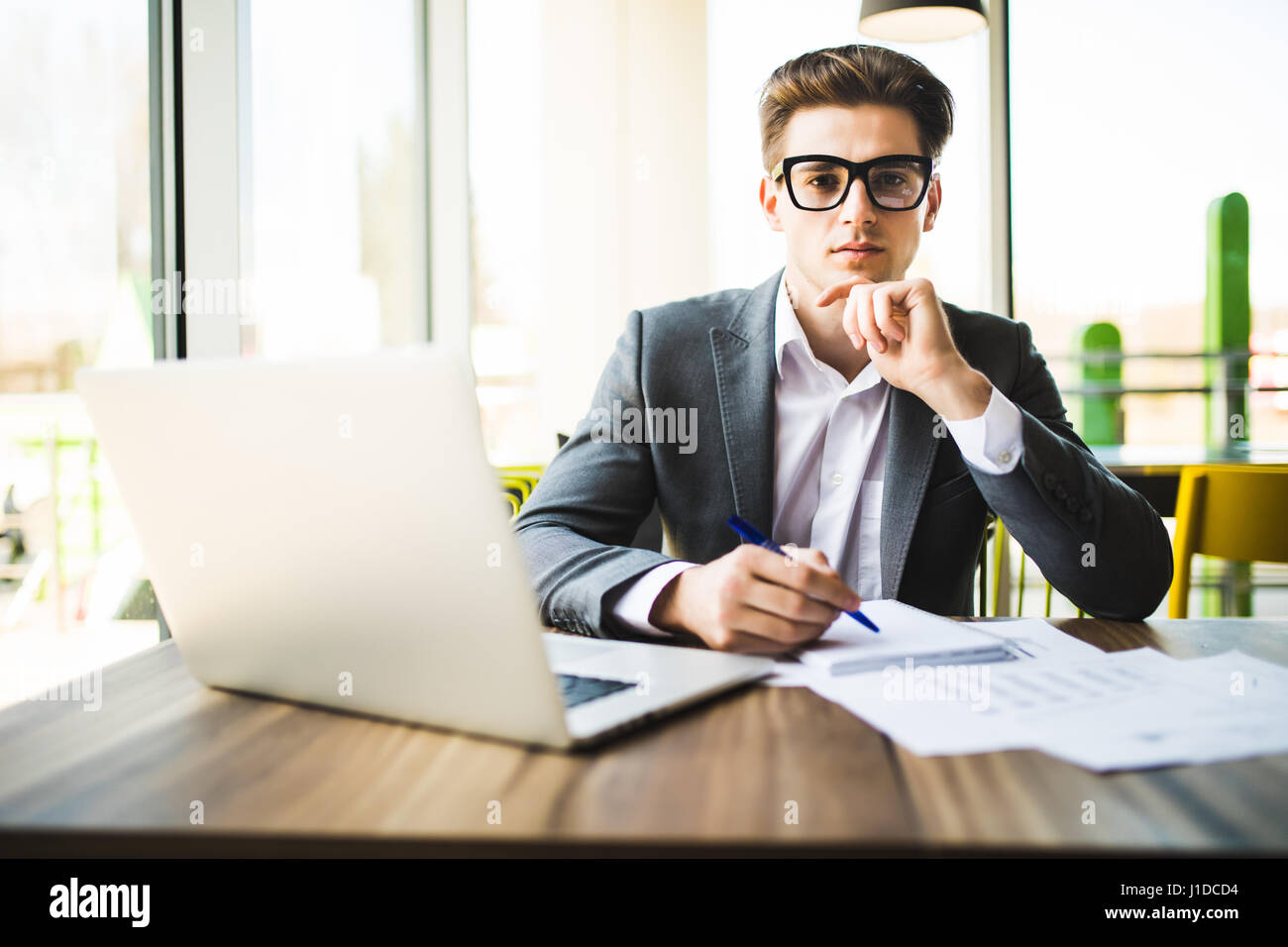 Happy man entering data from home on laptop Stock Photo - Alamy