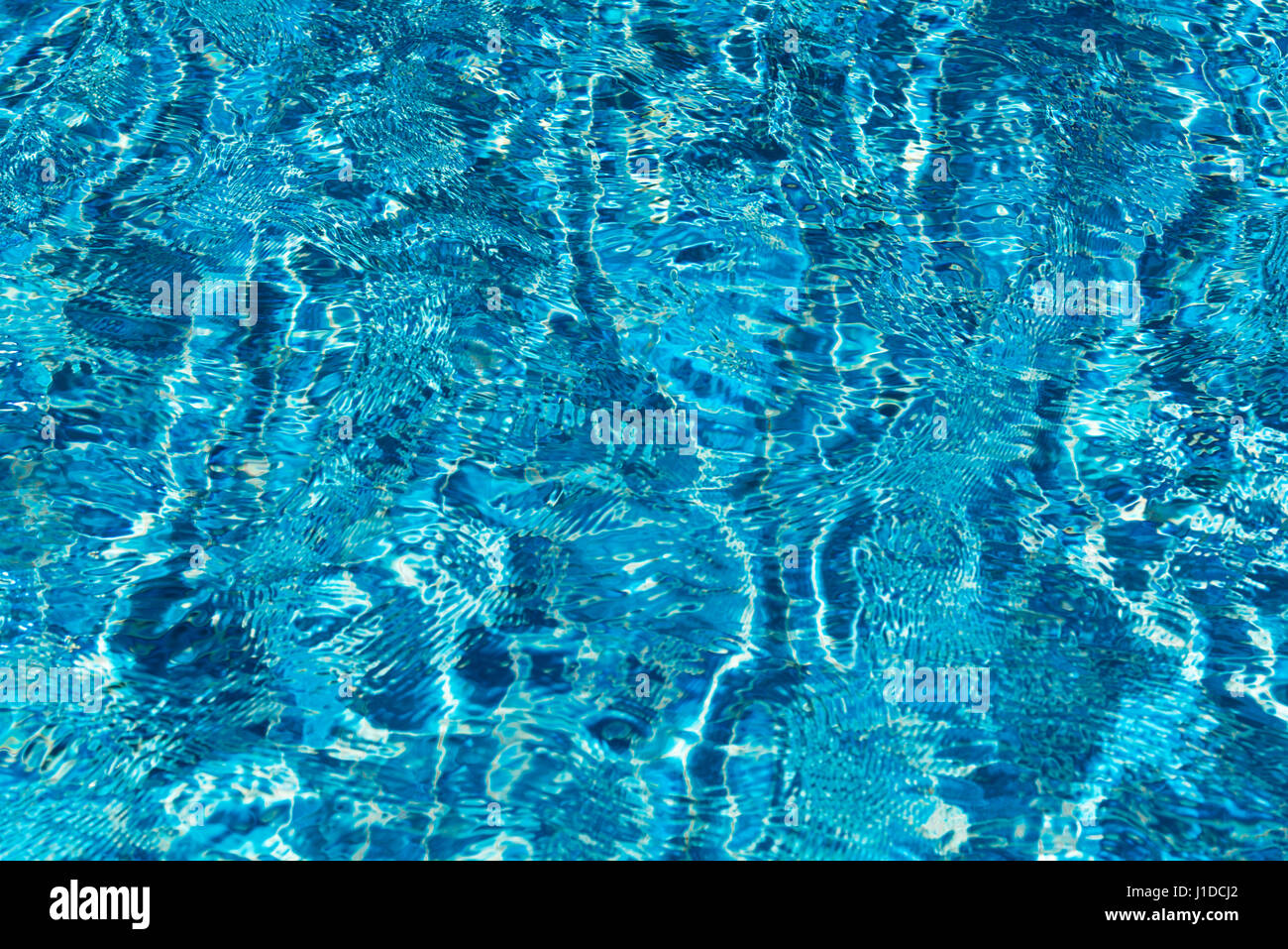 Abstract background texture of sparkling cool blue water in swimming ...