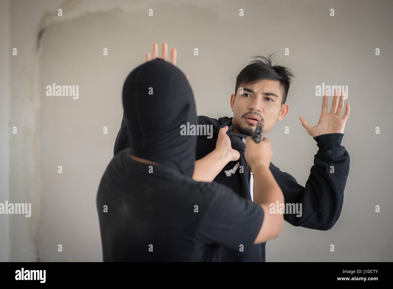 Men thief threatening handsome young man with gun Stock Photo - Alamy