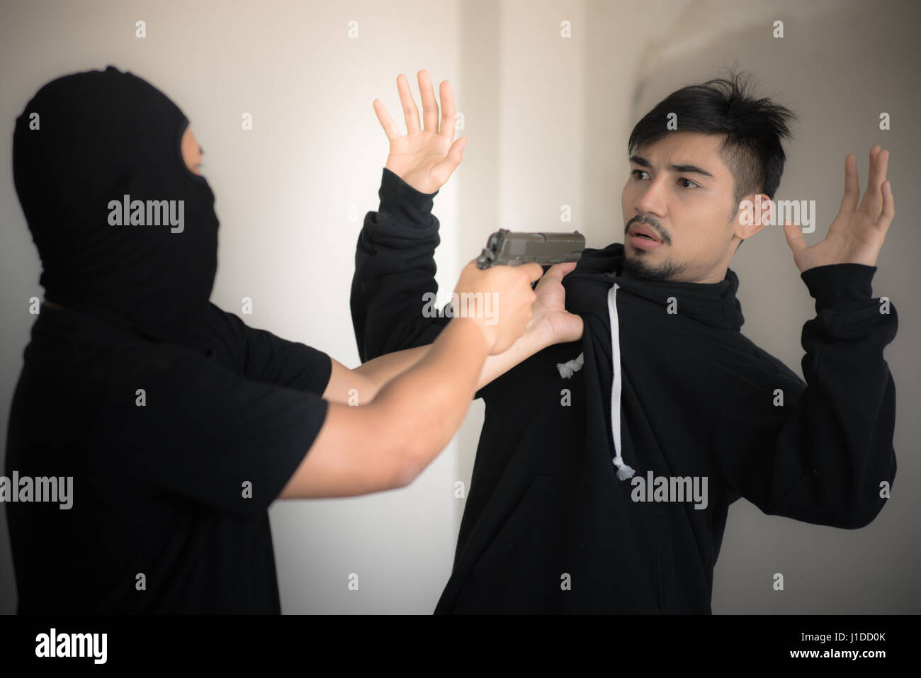 Hostage terrorist burglar threatening gun hi-res stock photography and ...