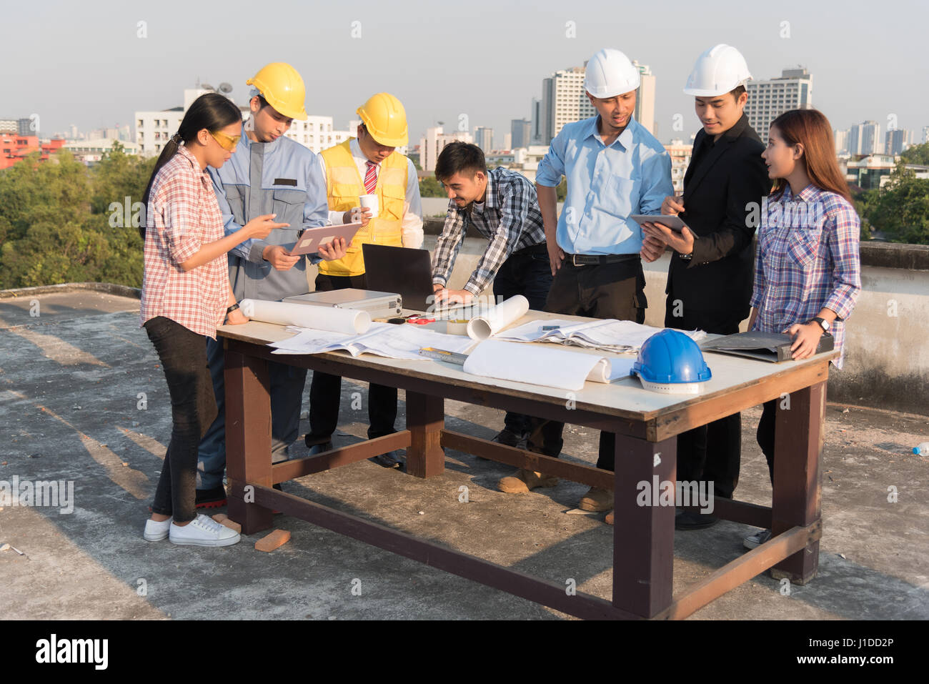 Handsome asian engineer looking at computer laptop with teamwork and ...