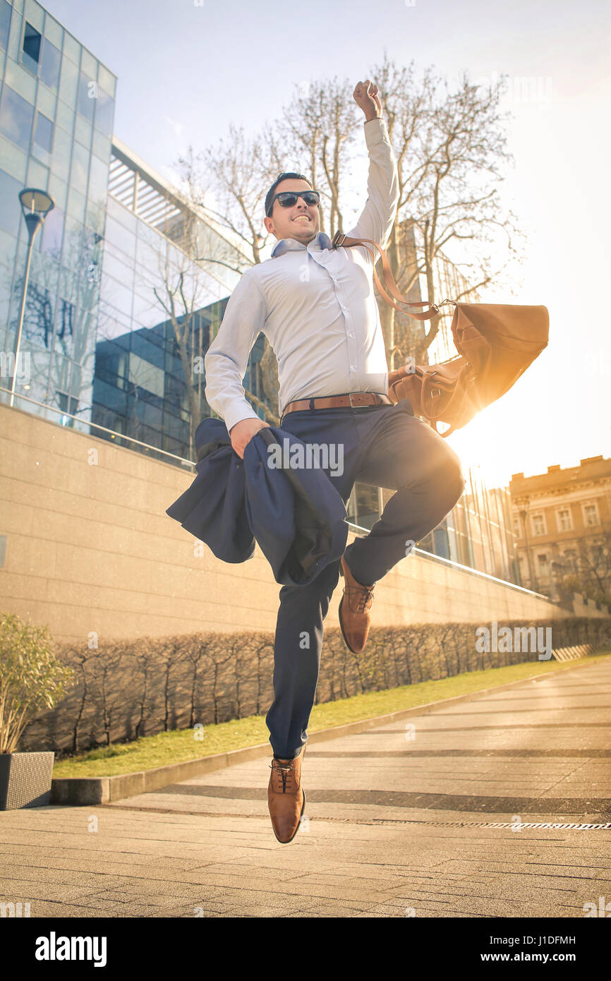 Successful businessman jumping high Stock Photo - Alamy