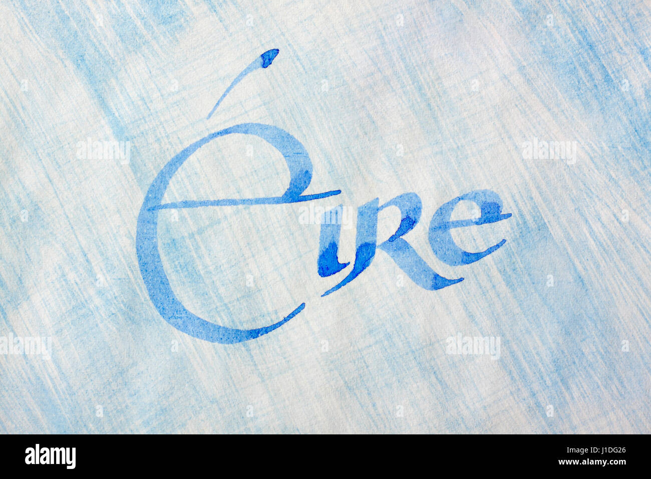 Handwritten country name over blue painted paper background. Ireland ...