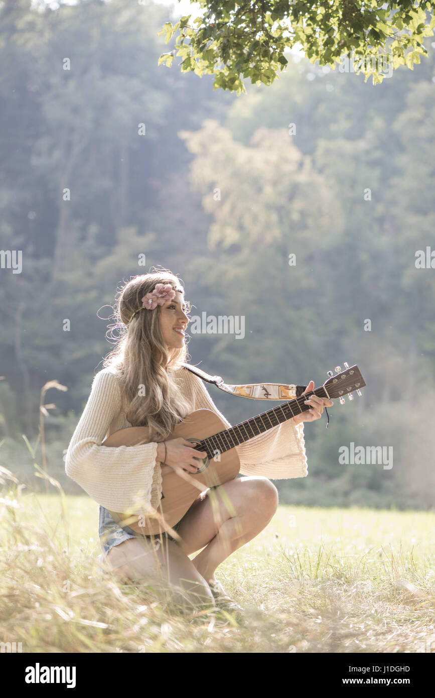 Young singer song-writer musician guitar girl in autumn forest, Vienna ...