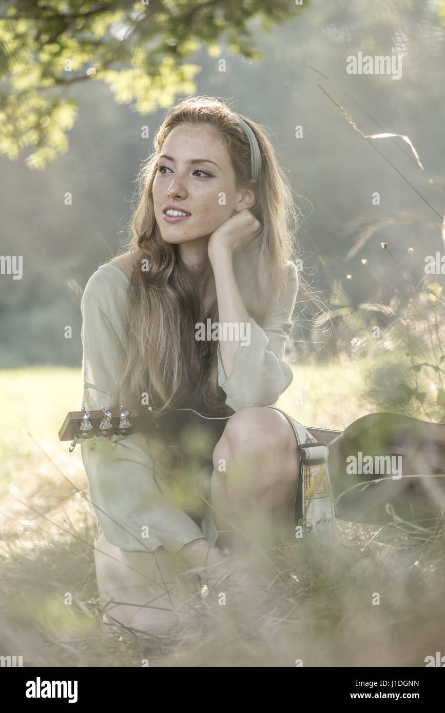 Young singer song-writer musician guitar girl in autumn forest, Vienna ...