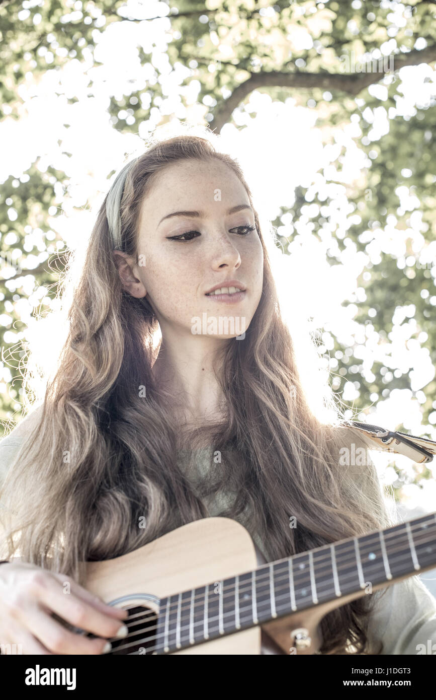 Young singer song-writer musician guitar girl in autumn forest, Vienna ...