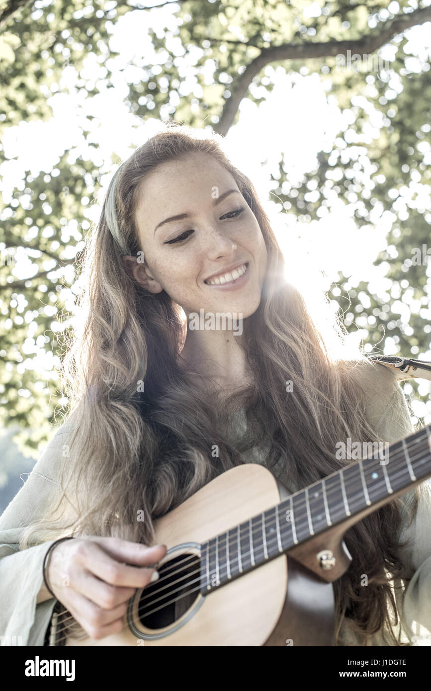 Young singer song-writer musician guitar girl in autumn forest, Vienna ...