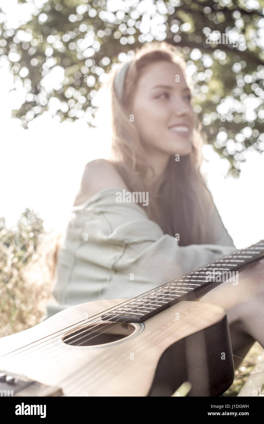 Young singer song-writer musician guitar girl in autumn forest, Vienna ...