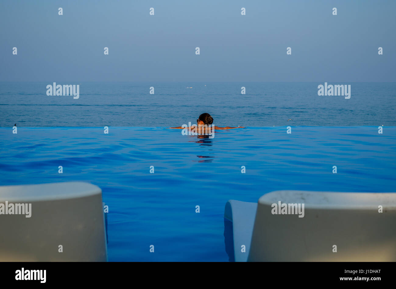 Swimming pool overlapping the sea Stock Photo - Alamy