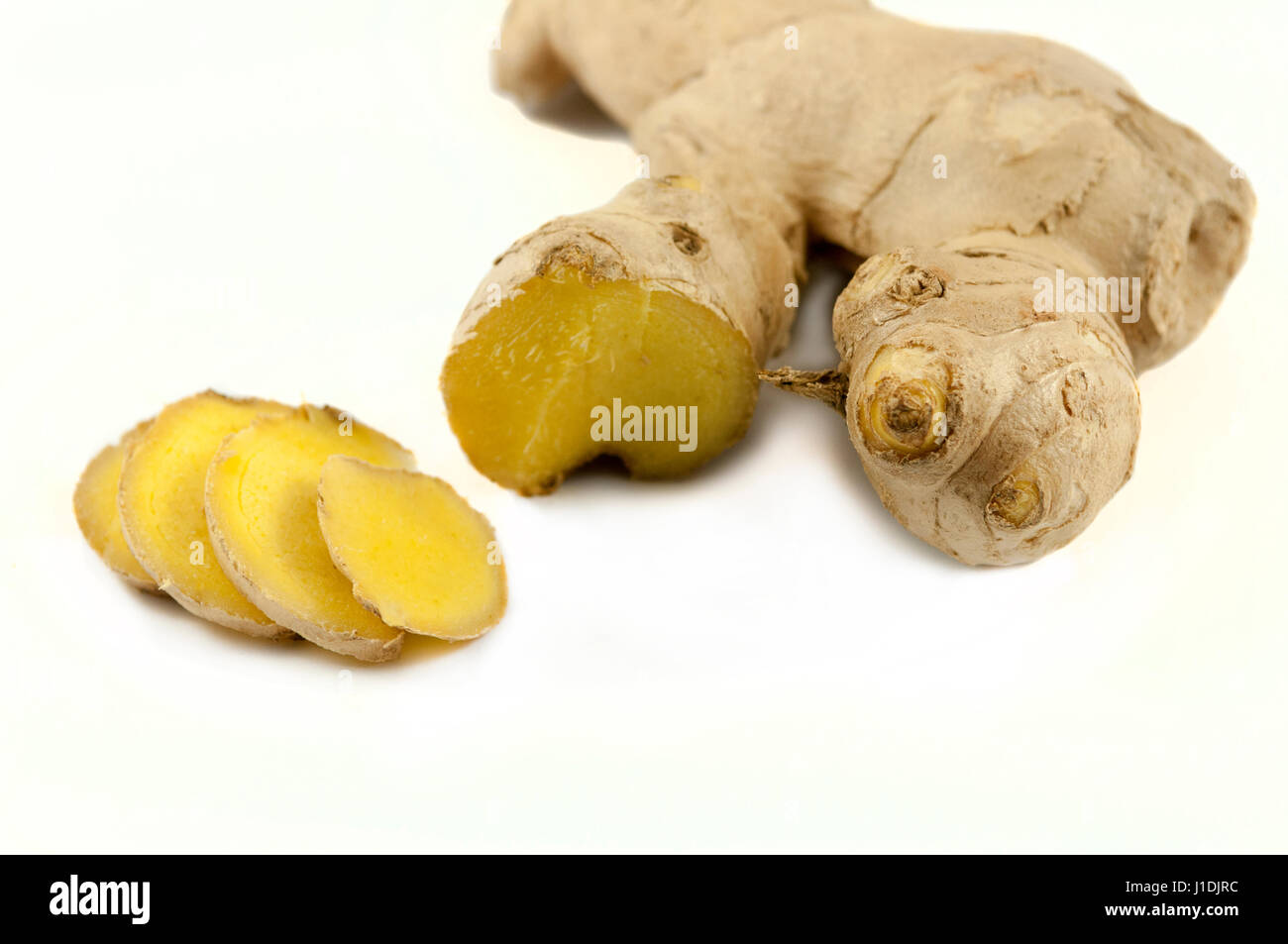 Ginger root with cut pieces Stock Photo - Alamy