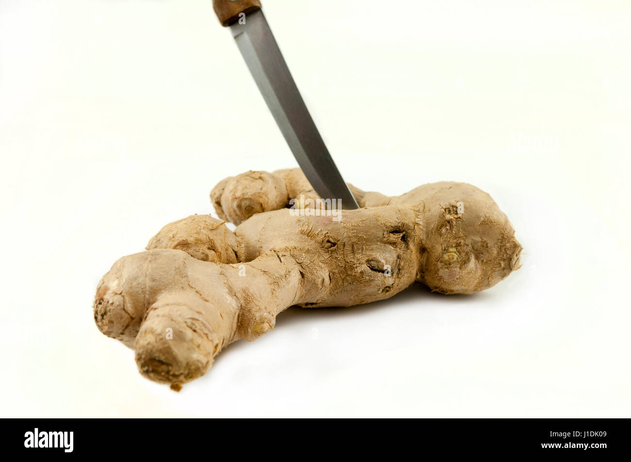 Ginger root with knife Stock Photo - Alamy