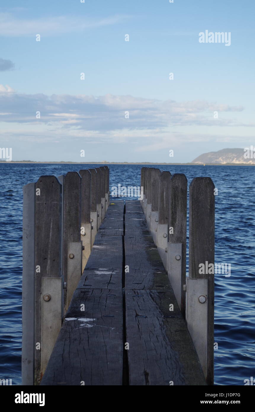 Wood jetty overlooking a quiet harbour Stock Photo - Alamy