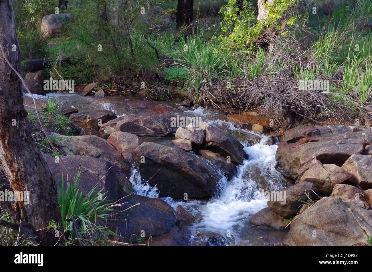 Waterfall flowing down stream hi-res stock photography and images - Alamy