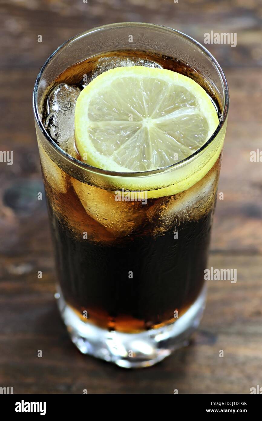 glass of cola served with ice cubes and a lemon slice Stock Photo - Alamy