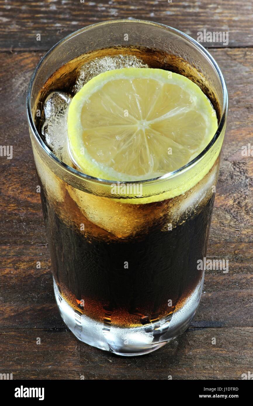 glass of cola served with ice cubes and a lemon slice Stock Photo - Alamy