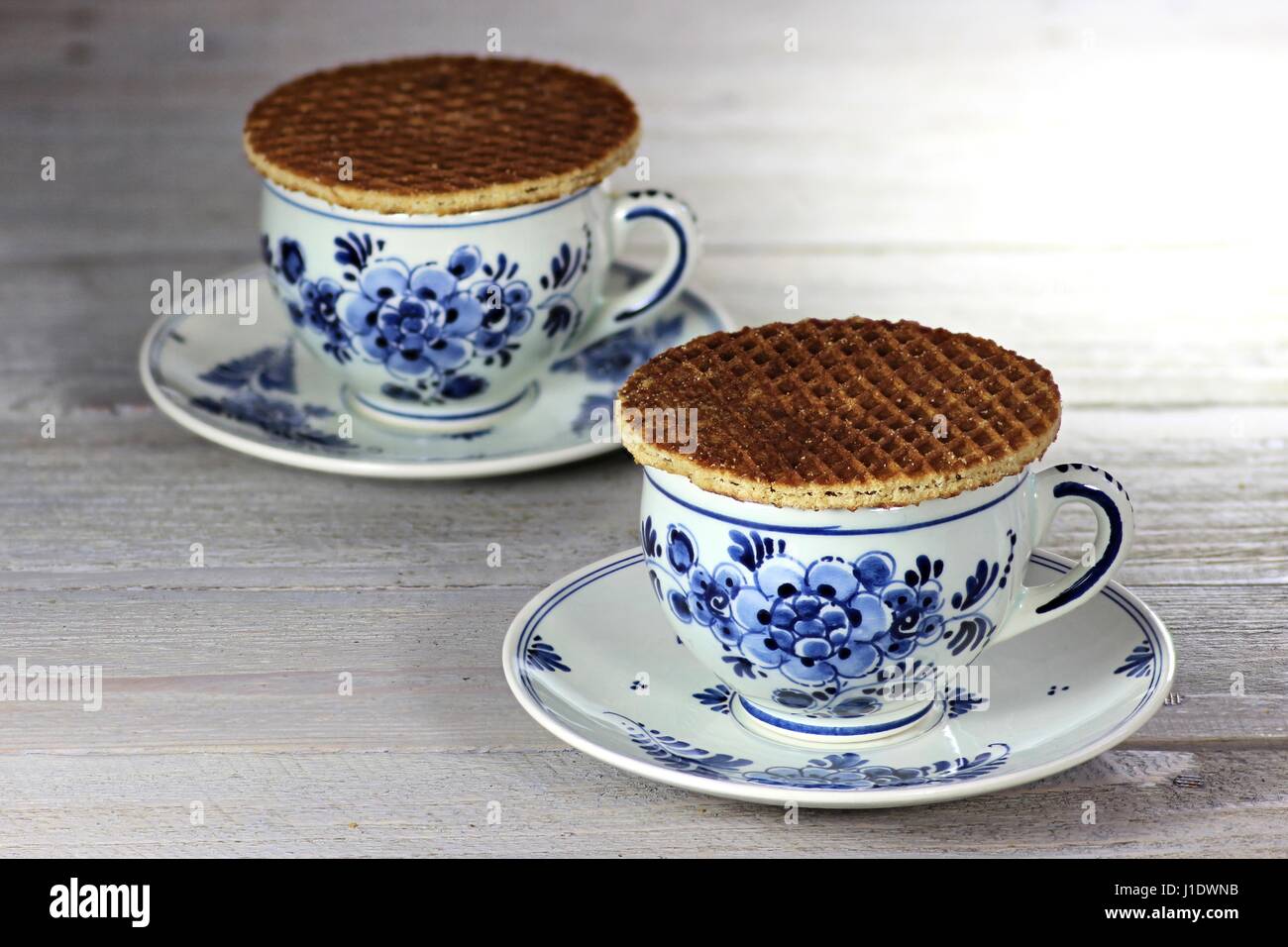 traditional Dutch syrup waffles with Delftware on wooden background ...