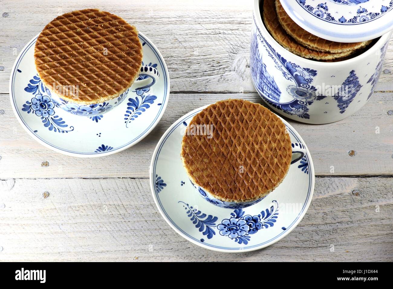 traditional Dutch syrup waffles with Delftware on wooden background ...