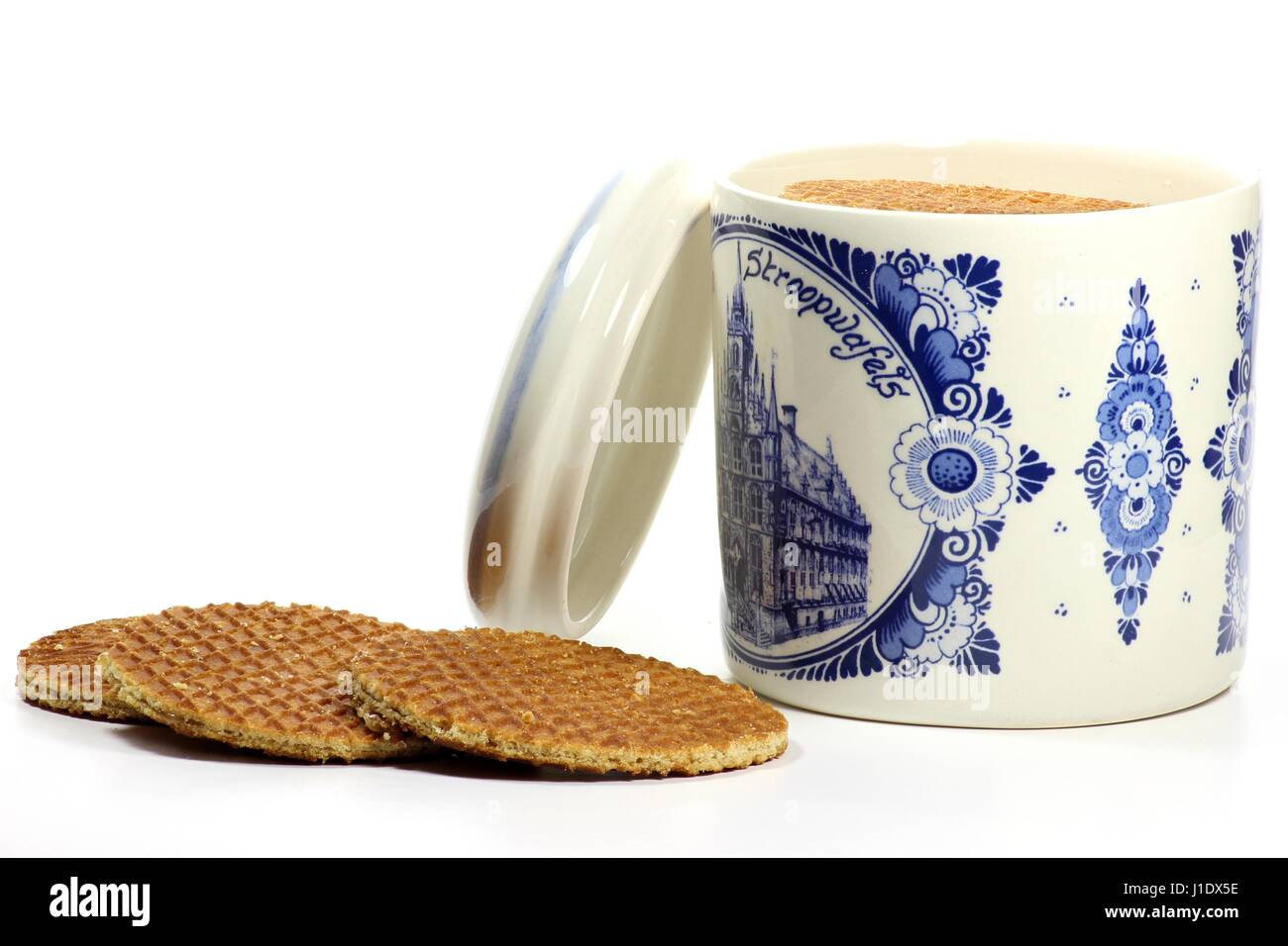 traditional Dutch syrup waffles in a Delftware container isolated on ...