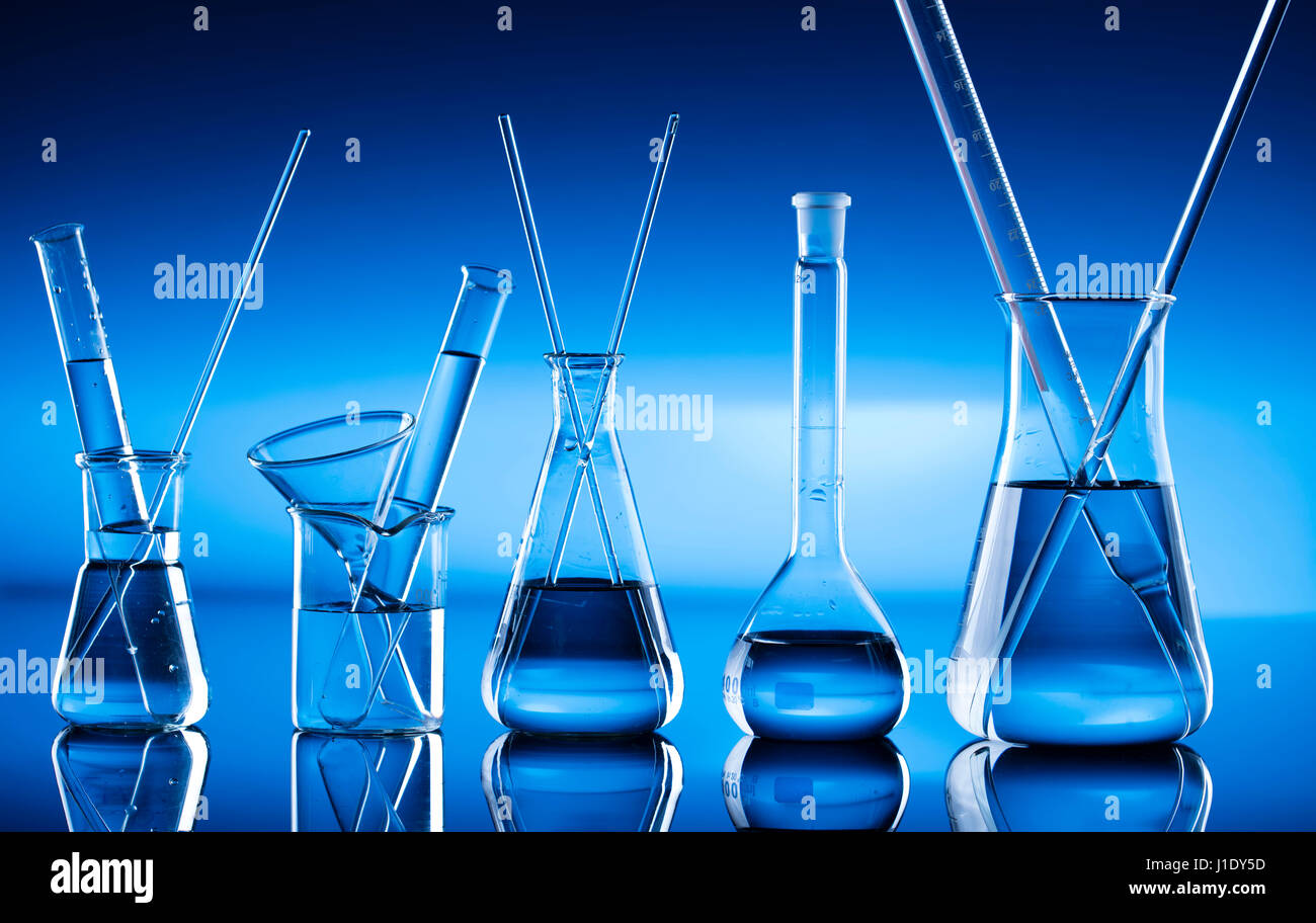 Modern laboratory equipment , set of different glassware on blue ...
