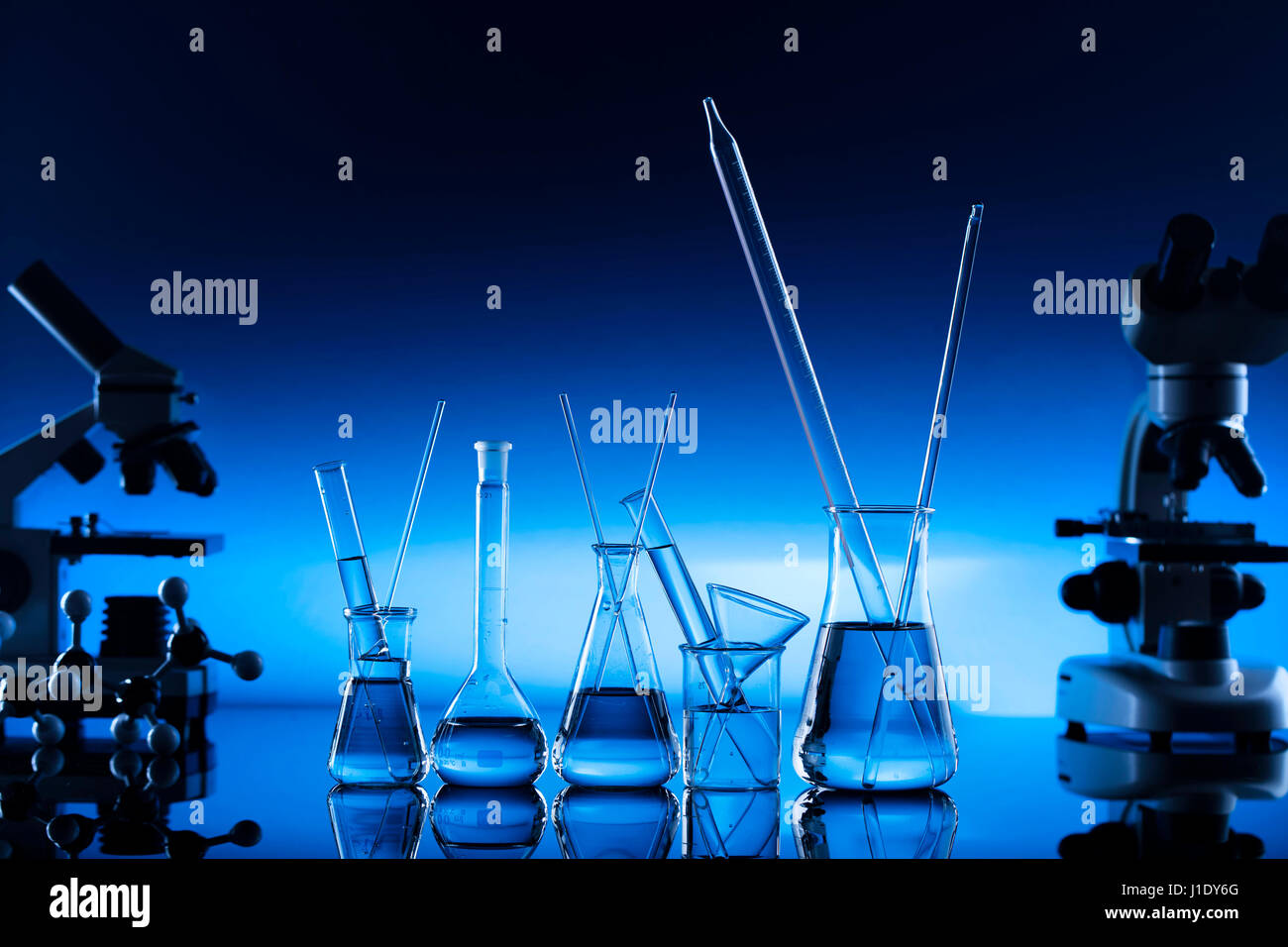 Modern laboratory equipment , set of different glassware on blue ...