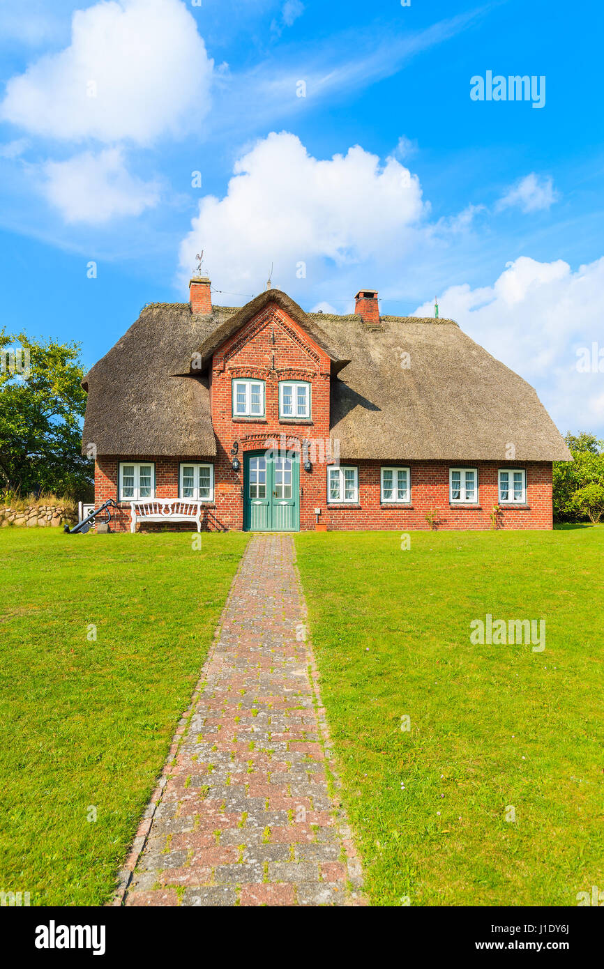 Typical red brick Frisian house with thatched roof on Sylt island in ...