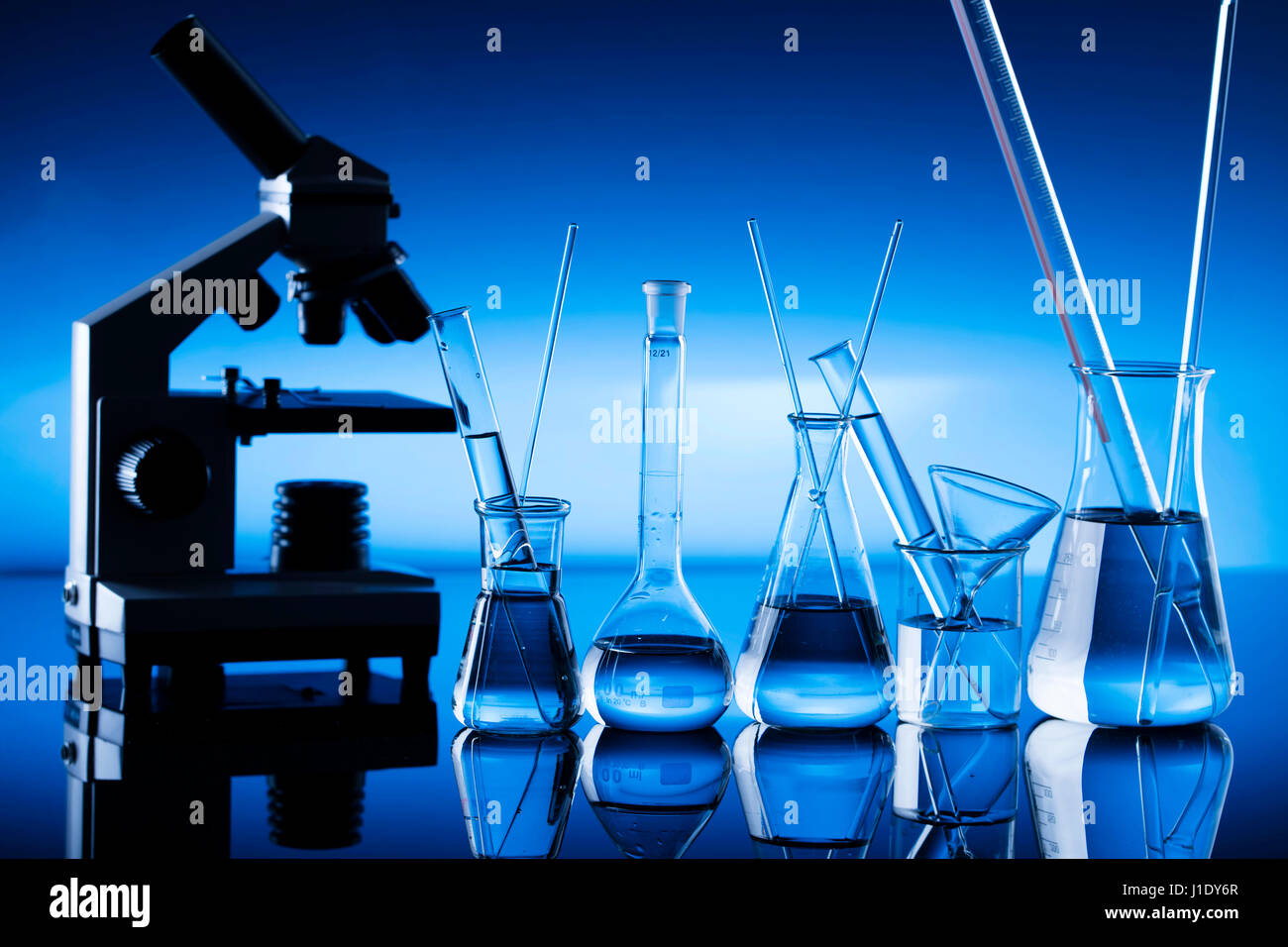 Modern laboratory equipment , set of different glassware on blue ...