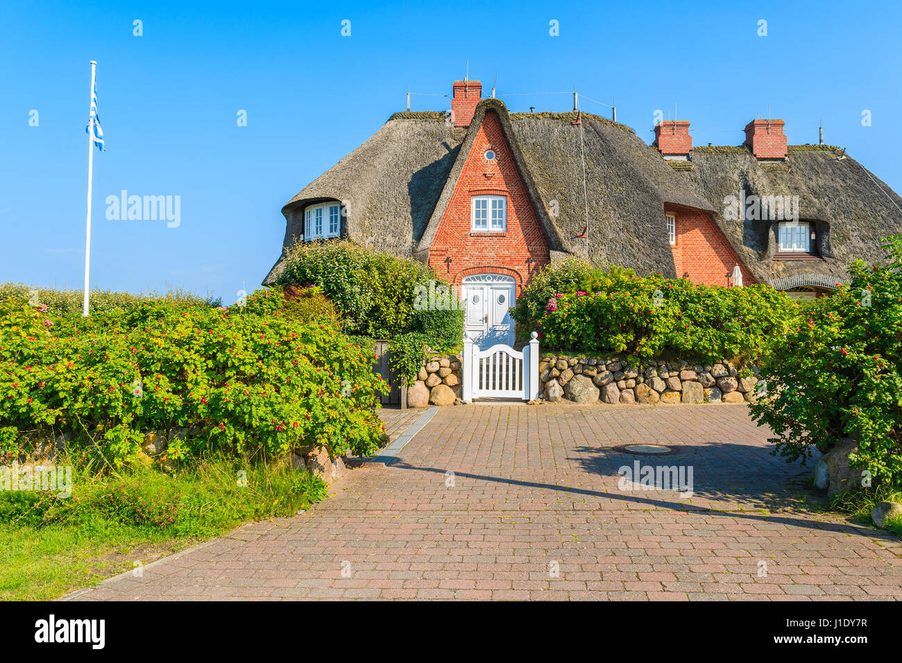 Typical frisian house with straw roof in Kampen village on Sylt island ...