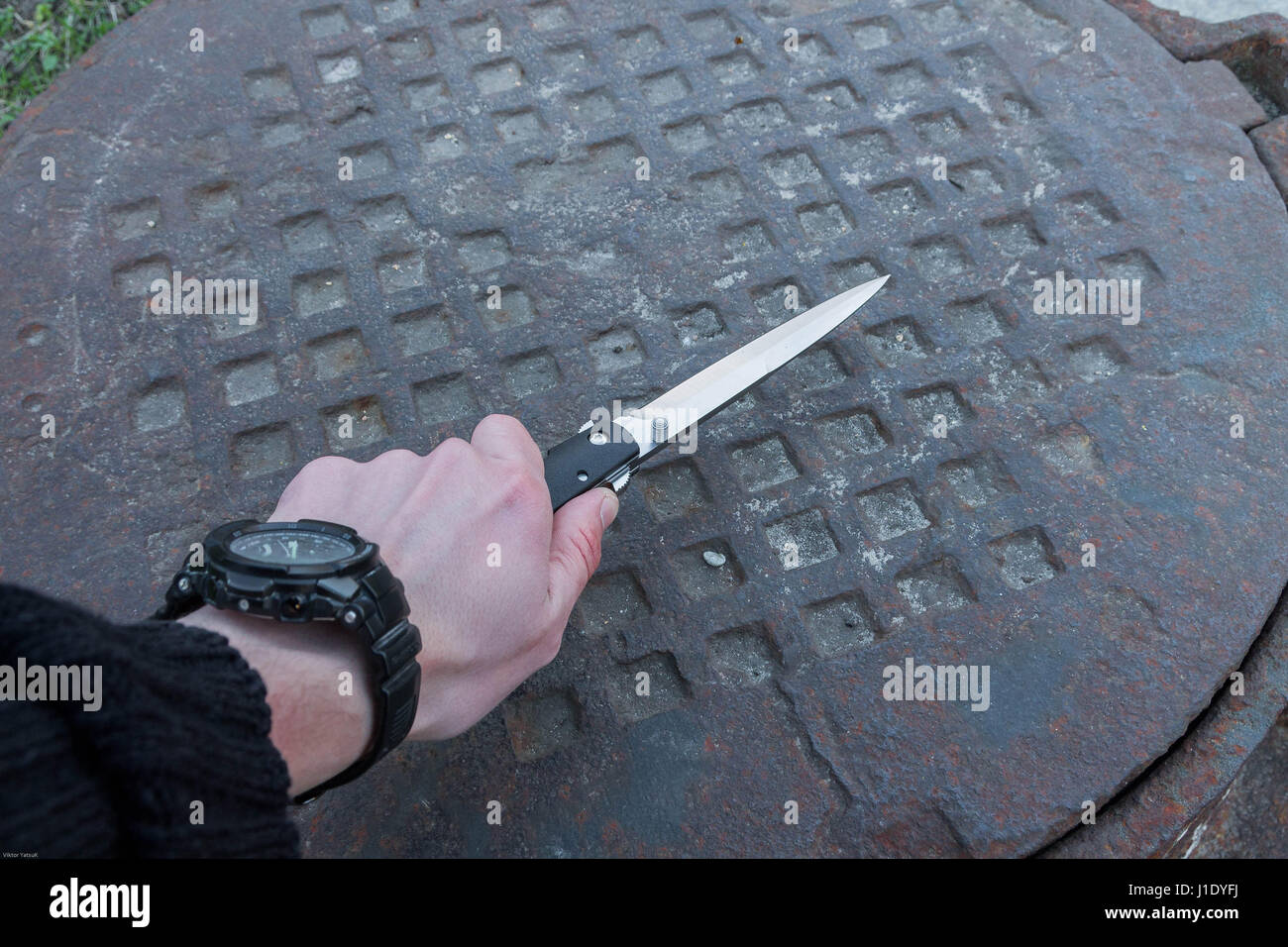 Knife in a man hands. Rusty background. Rotten iron Stock Photo - Alamy