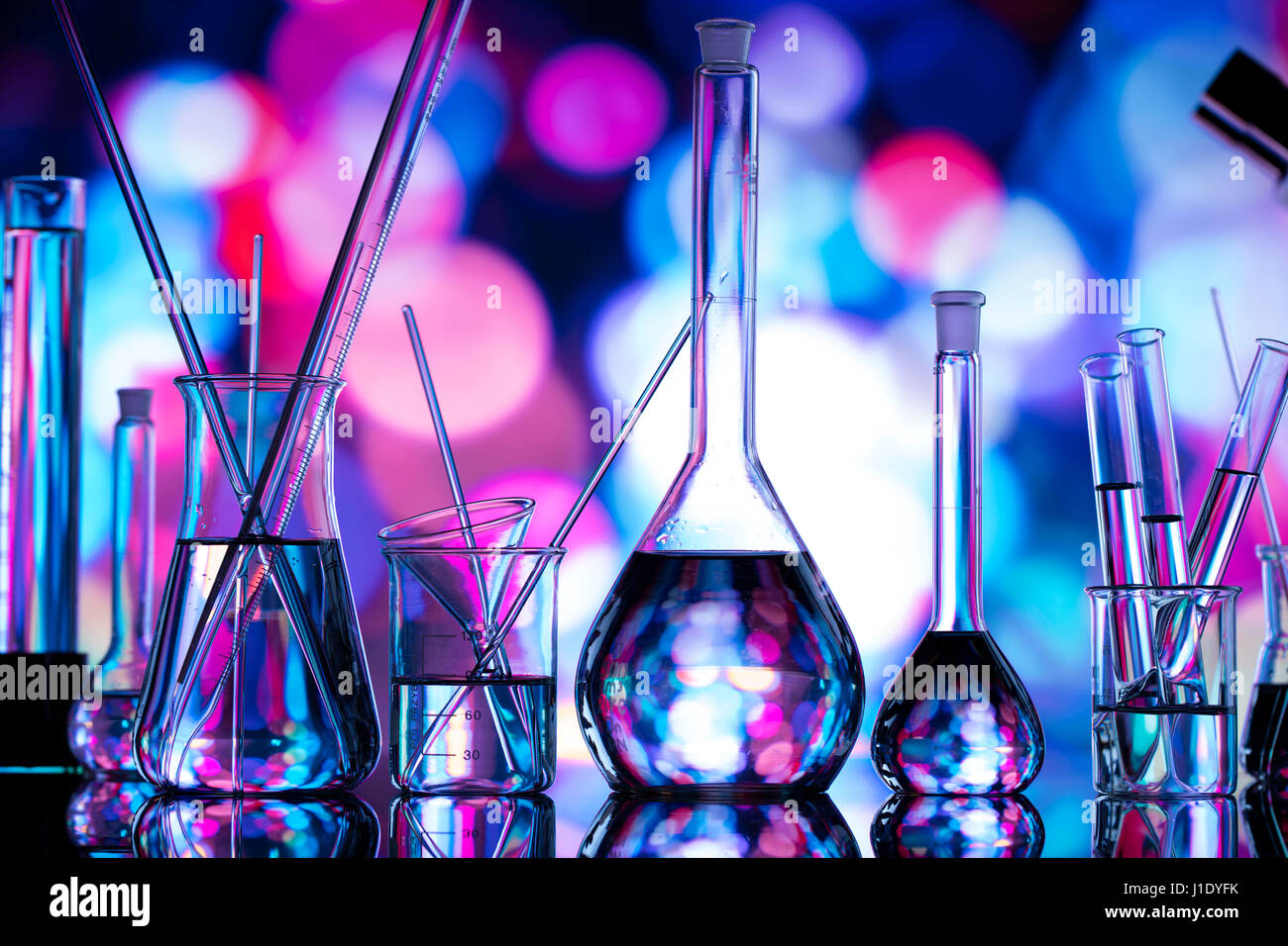 Modern laboratory equipment , set of different glassware on blue ...