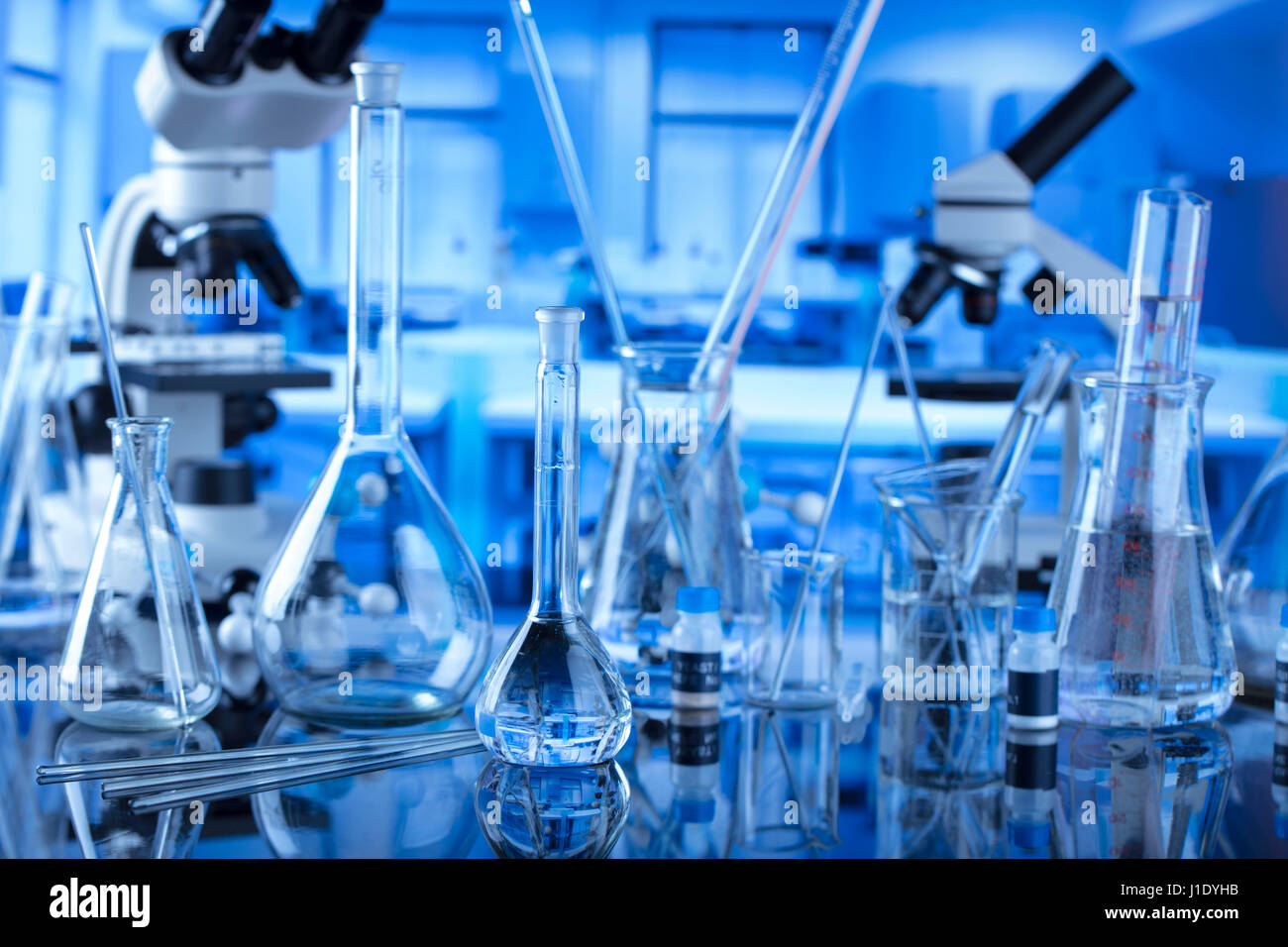 Modern laboratory equipment , set of different glassware on blue ...