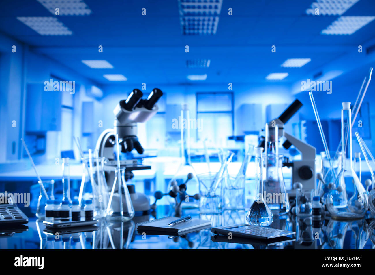 Modern laboratory equipment , set of different glassware on blue ...