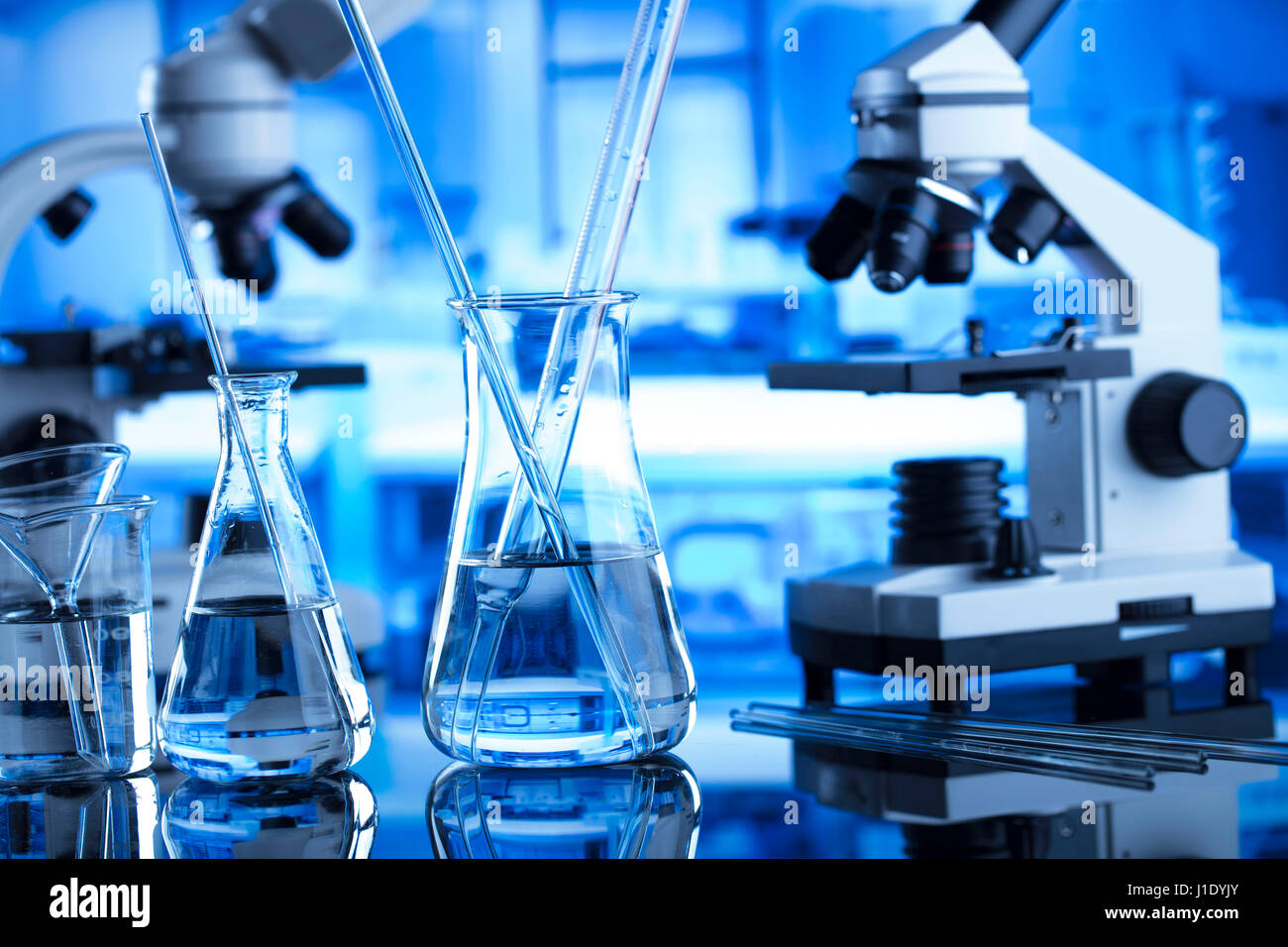 Modern laboratory equipment , set of different glassware on blue ...