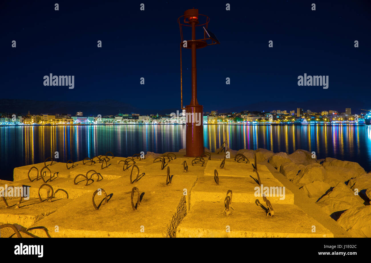 Night shot of lighthouse and colorful city lights. Split, Croatia Stock ...