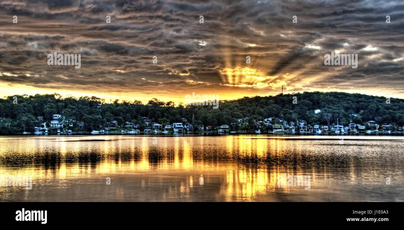 Golden Crepuscular sunrise water reflections. An inspirational ...