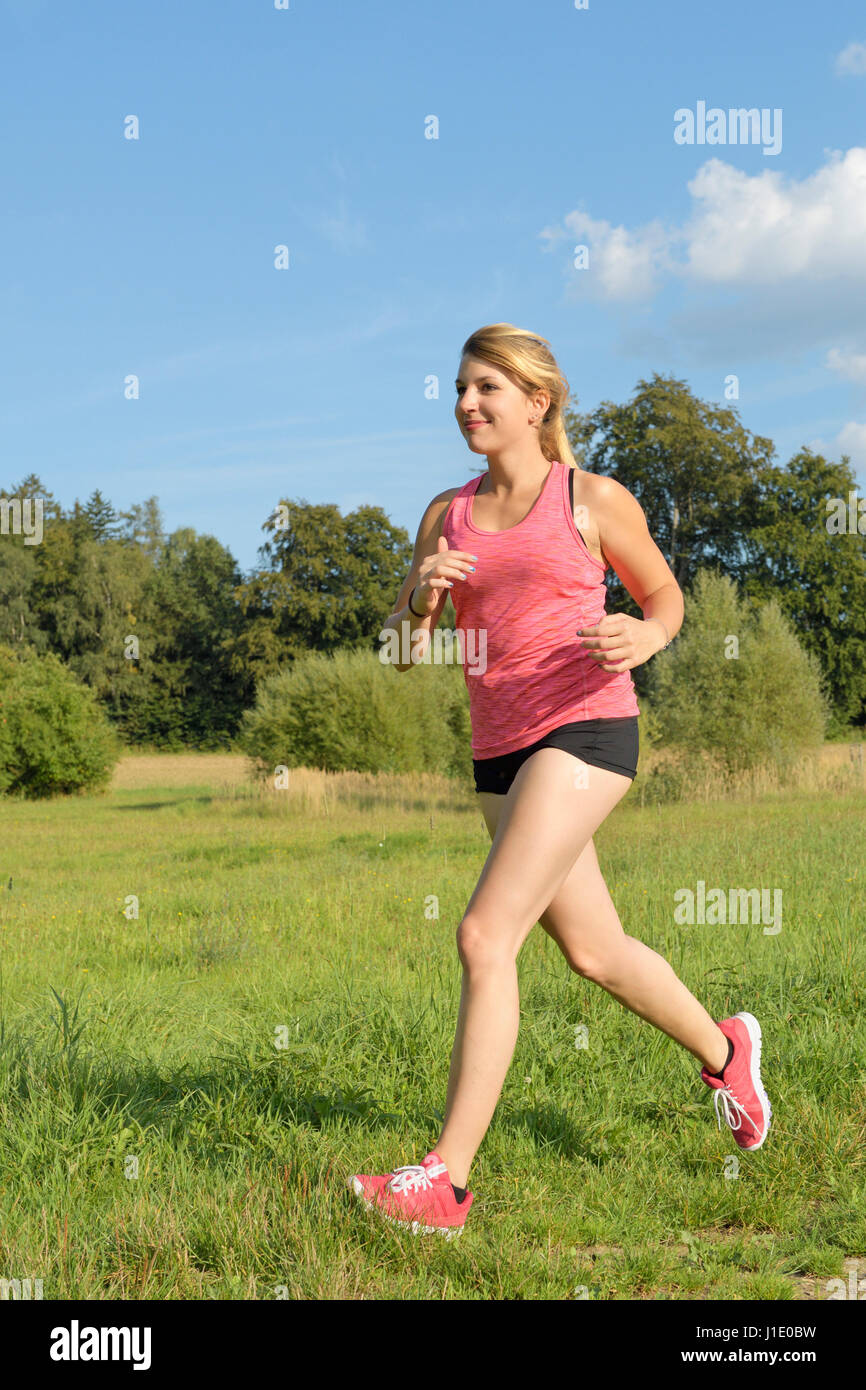 Young woman running Stock Photo - Alamy