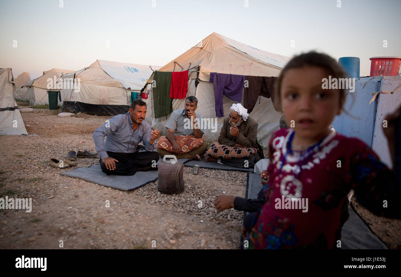 Bashiqa, Iraq. 20th Apr, 2017. Refugees stand and sit in front of tents ...