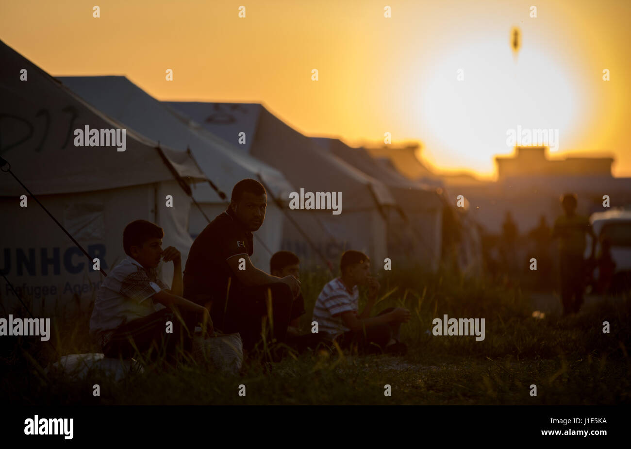 Bashiqa, Iraq. 20th Apr, 2017. dpatop - Refugees stand and sit in front ...