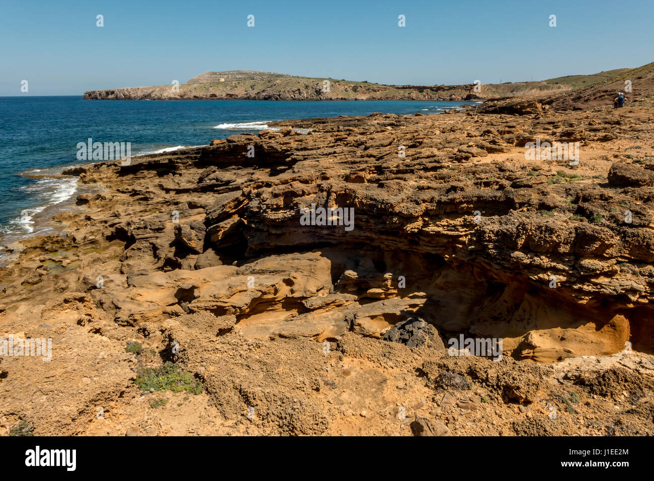 Rugged volcanic landscape on the coast at Fornells in Menorca Stock ...
