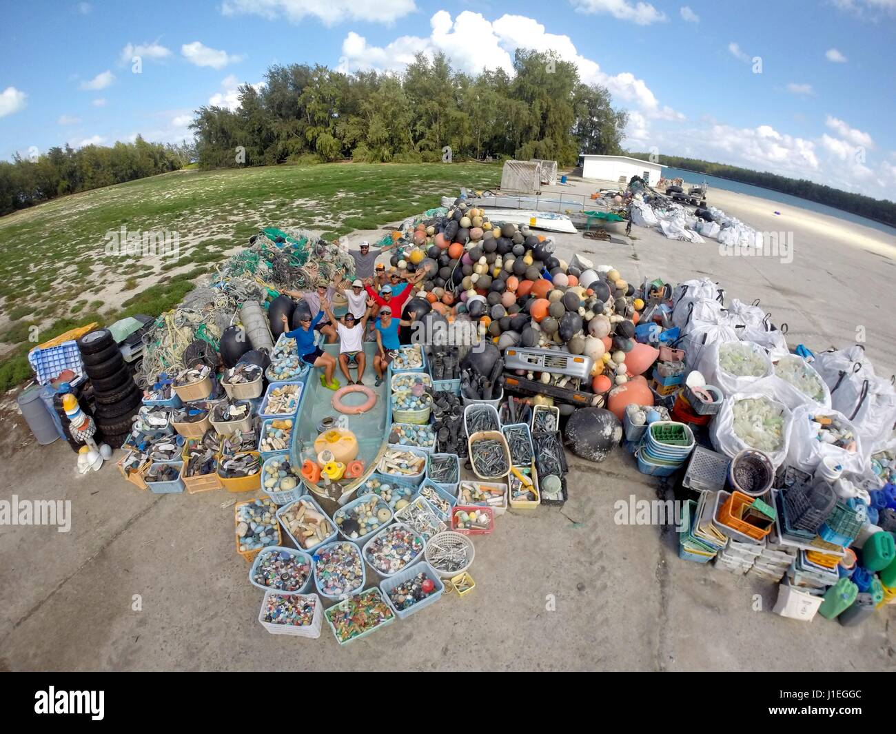 Volunteers with NOAA Marine Debris program pose with a mountain of ...