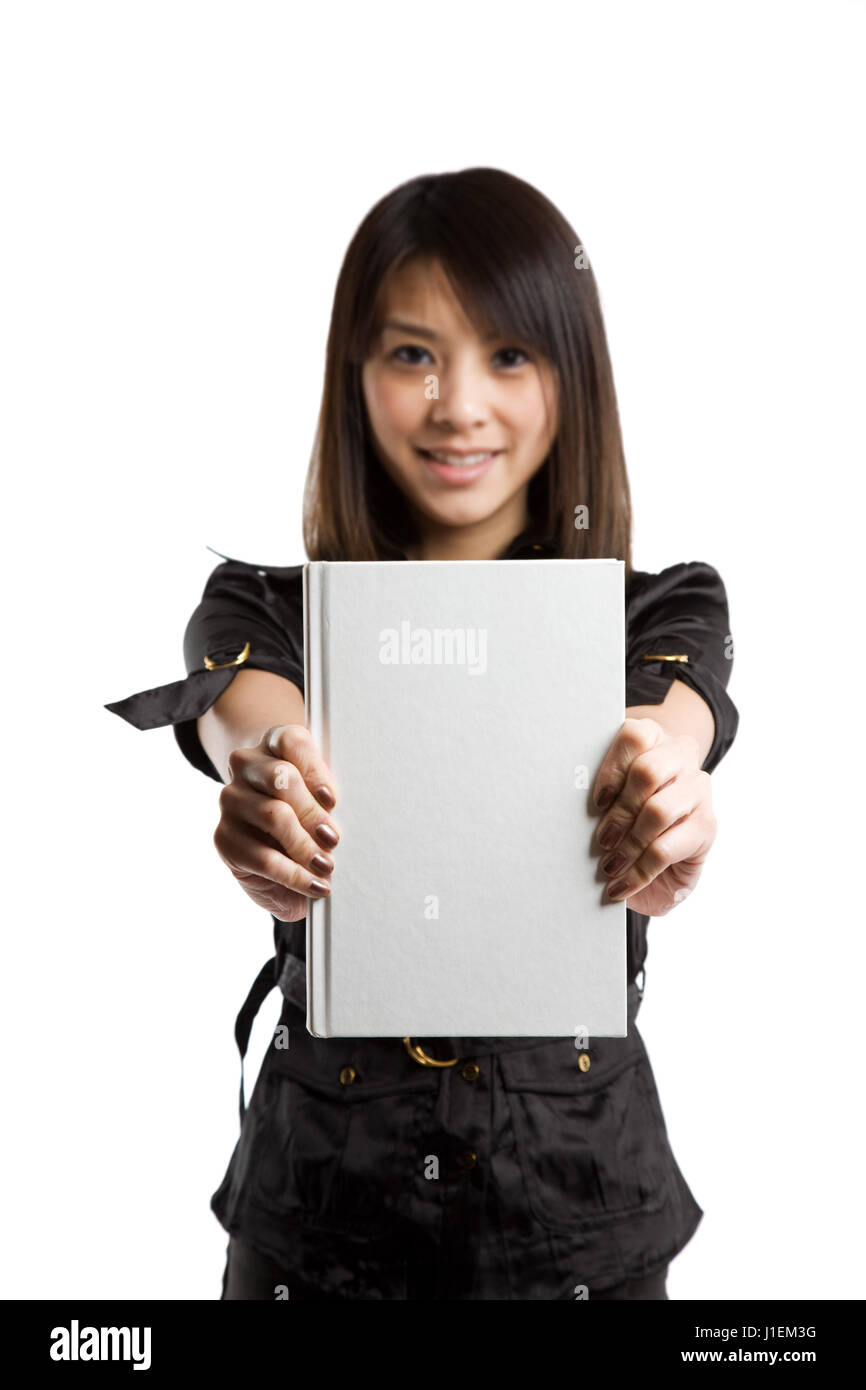 An isolated shot of a beautiful asian student showing a book with blank ...