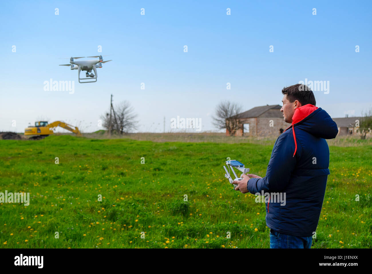 A man with a remote control in his hands. Flight control of the drone ...