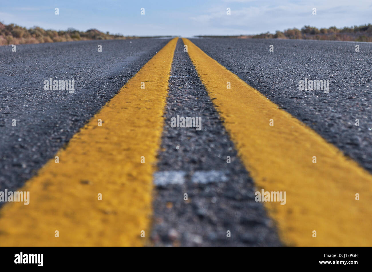 Close up asphalt with yellow lines Stock Photo - Alamy