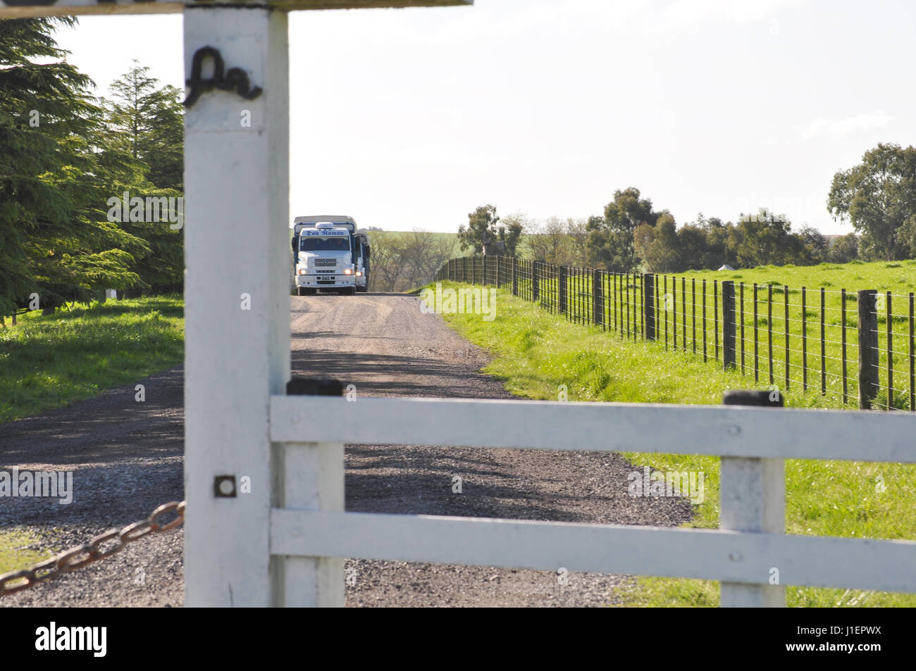 Farm entrance gate landscape background Stock Photo - Alamy