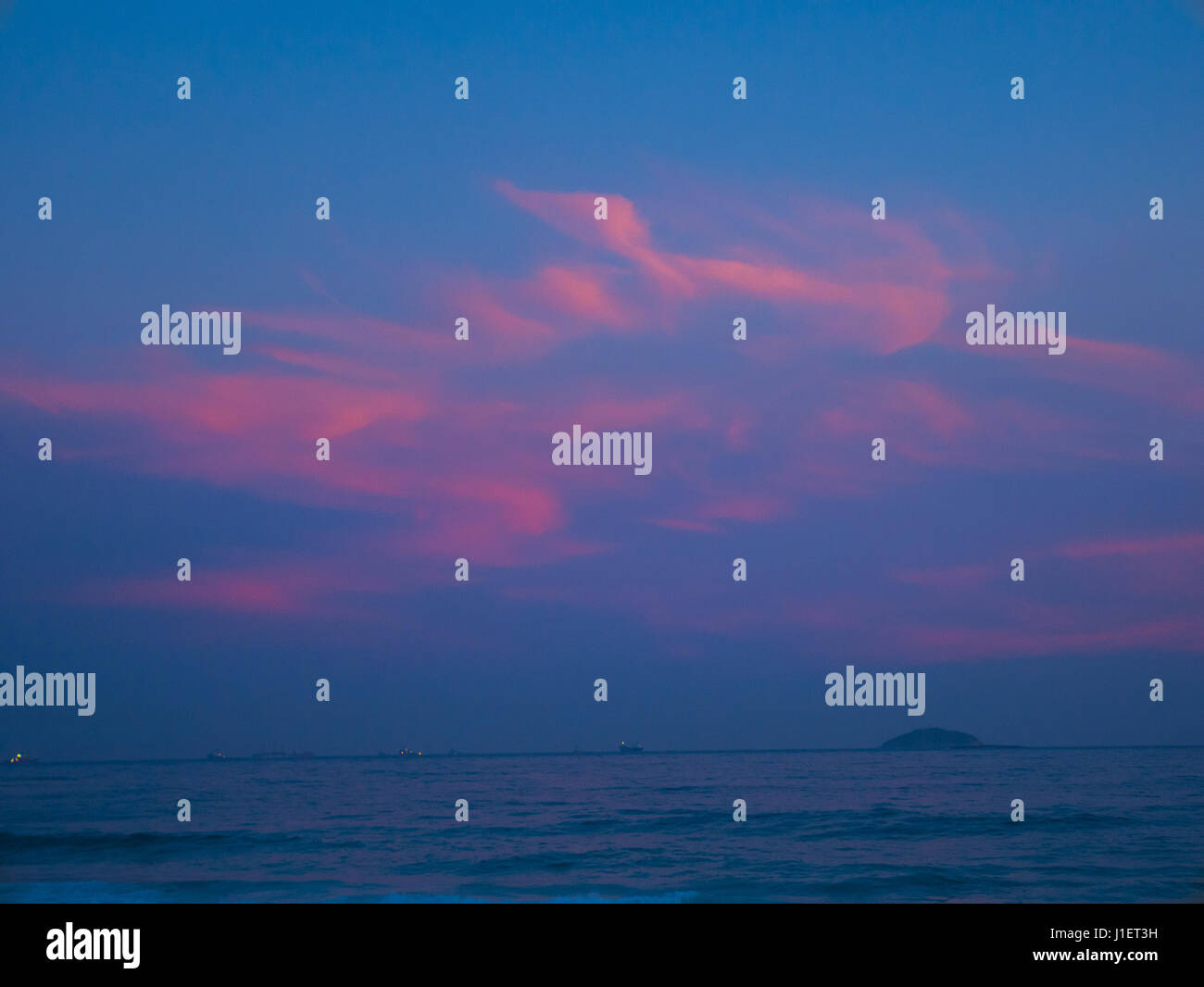 Sunset reflection on the beach Stock Photo - Alamy