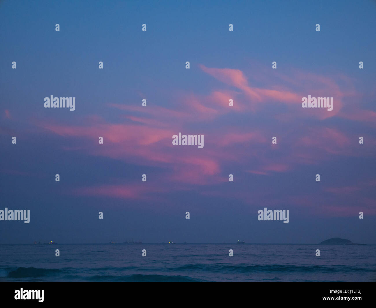 Sunset reflection on the beach Stock Photo - Alamy
