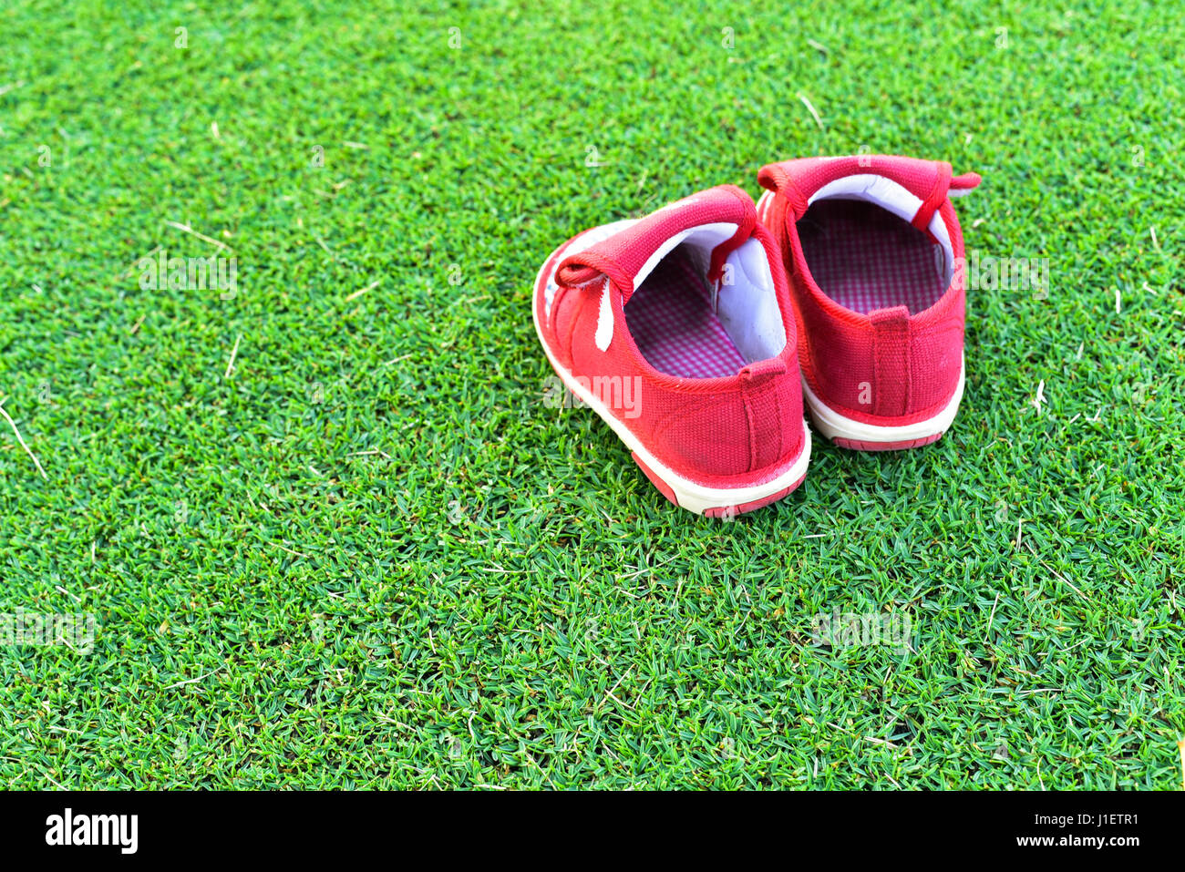 Little red shoes on grass Stock Photo - Alamy