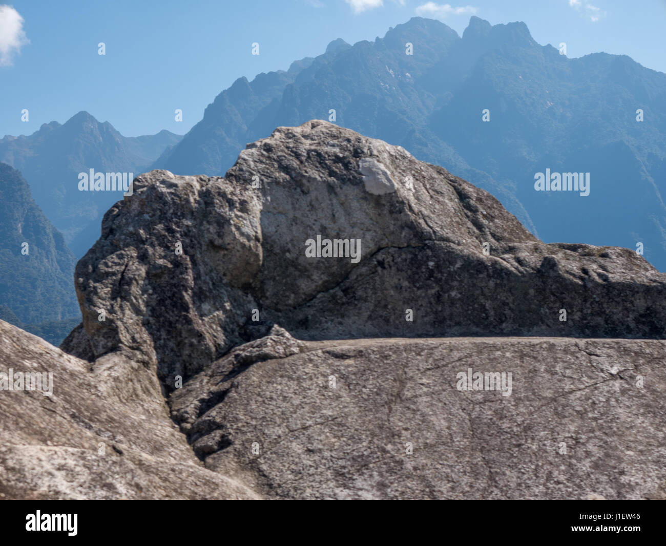 Carved rocks aligned with background mountains in Machu Picchu Ruins ...