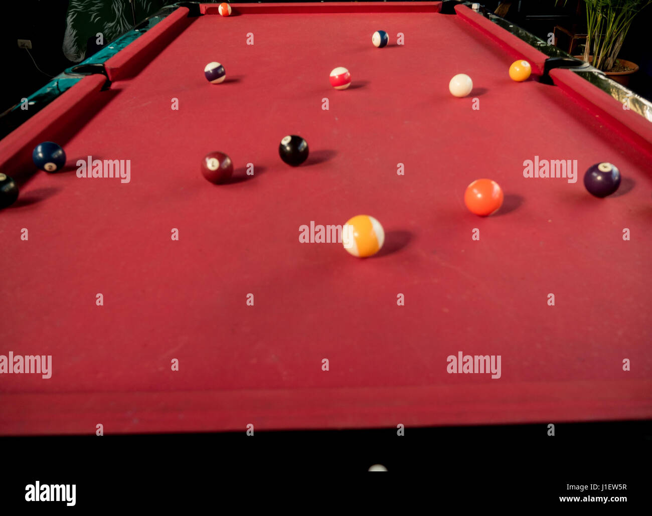 Pool balls on a red table Stock Photo - Alamy