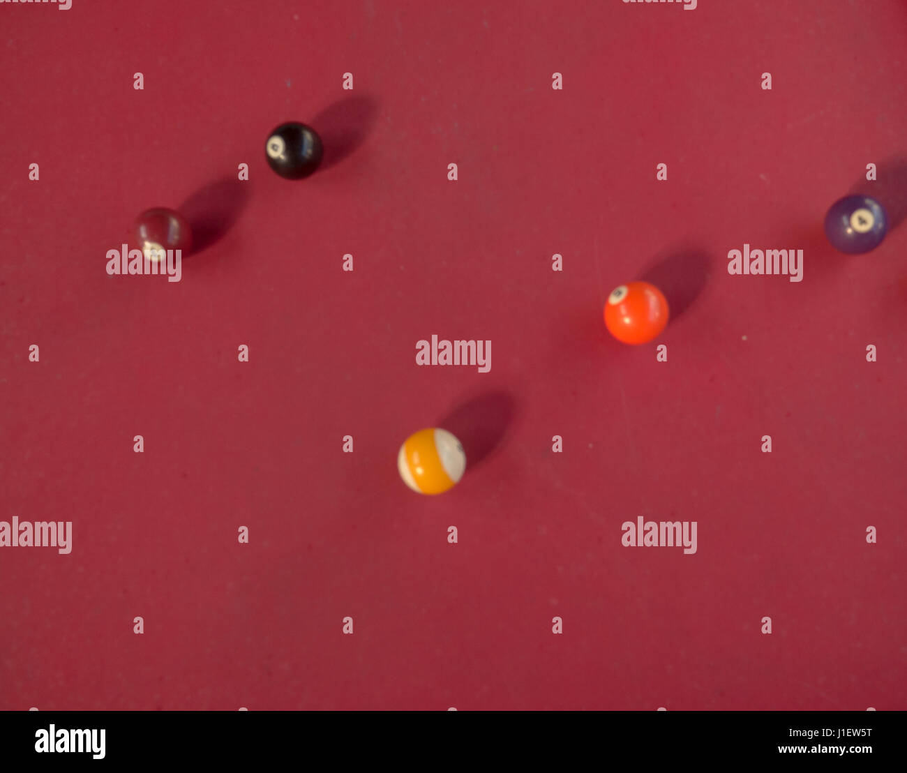 Pool balls on a red table Stock Photo - Alamy
