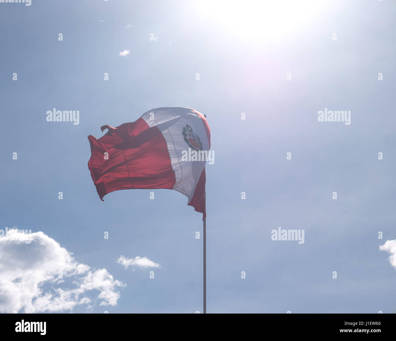 Flag of Peru waving against blue sky Stock Photo - Alamy
